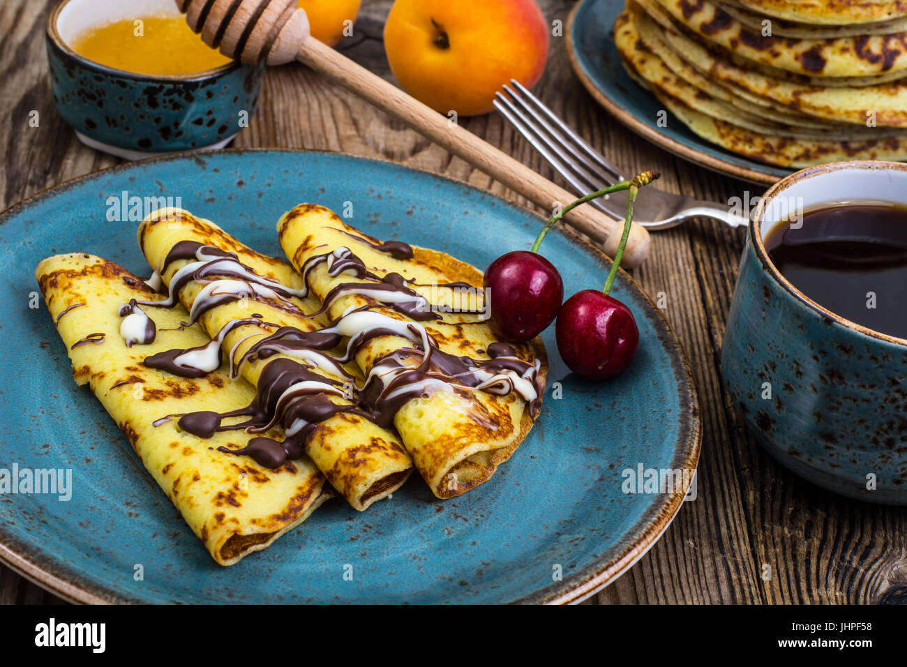 Traditional Russian breakfast pancakes with fruit and honey. Studio ...