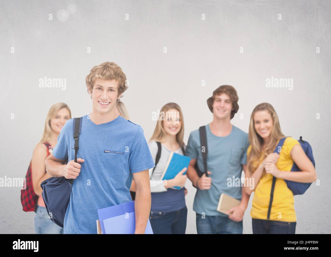 Digital composite of Group of students standing in front of blank grey ...