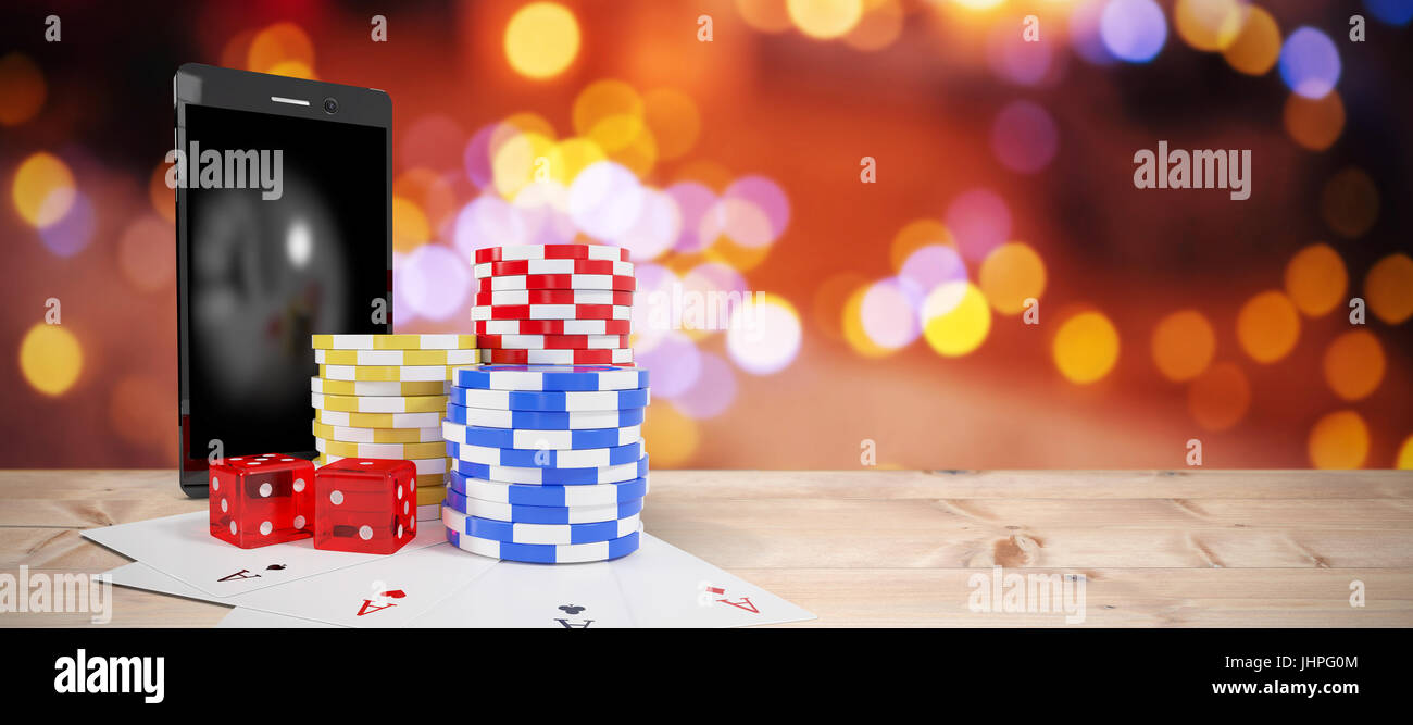Mobile phone with stack of gambling chips and playing cards against ...