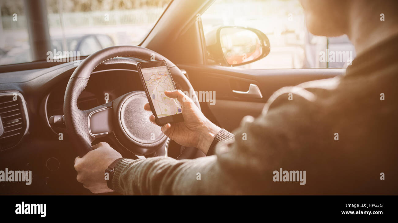 man looking at GPS on his phone inside his car Stock Photo - Alamy