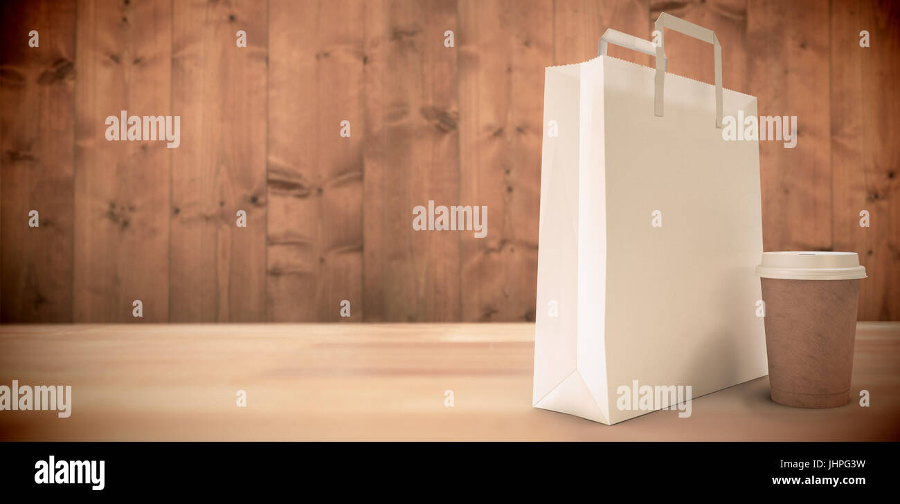 Disposable coffee cup and parcel bag against wooden planks Stock Photo ...
