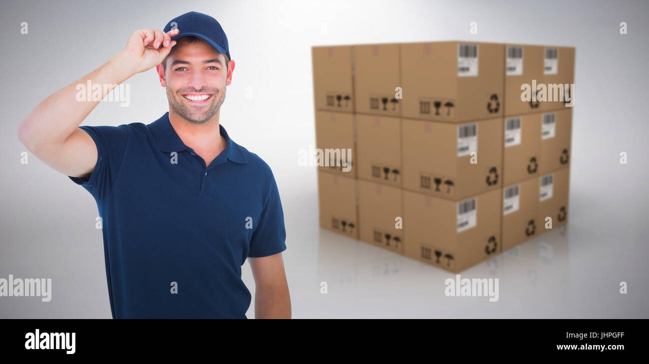 Portrait of happy delivery man wearing cap against grey background ...
