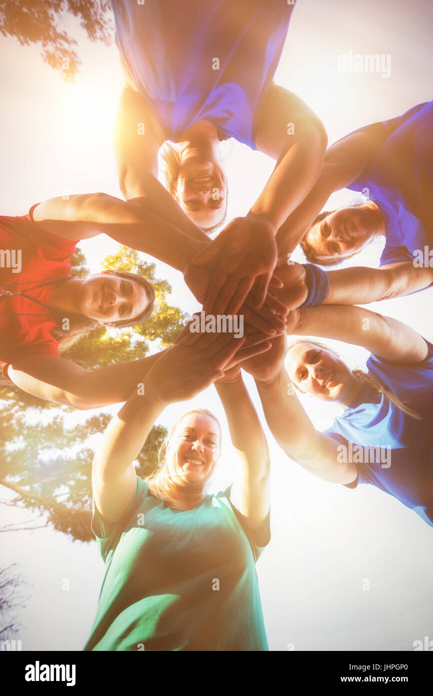 Portrait of fit womens group forming hand stack in the boot camp Stock ...
