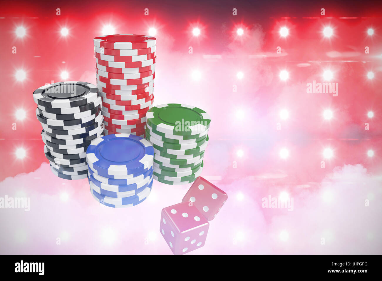 Stack of colorful casino tokens by dice against green floodlight at ...