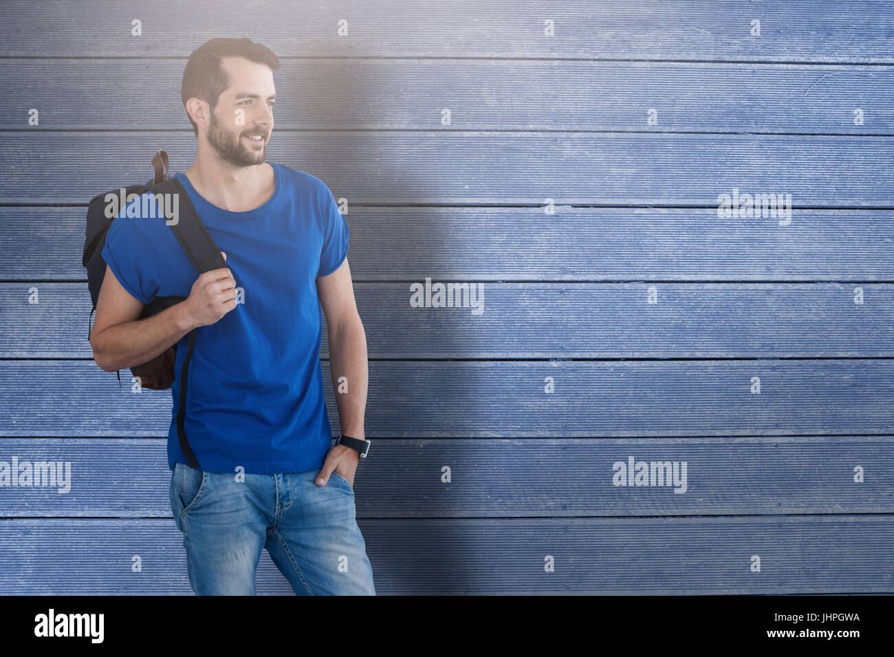 Model with backpack against white background against wooden surface ...
