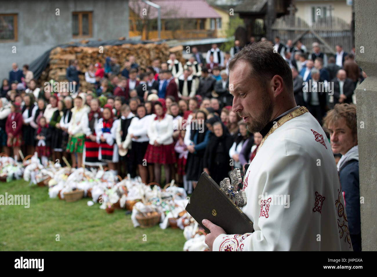 A christina orthodox priest blessing baskets of food after Eeaster mass ...