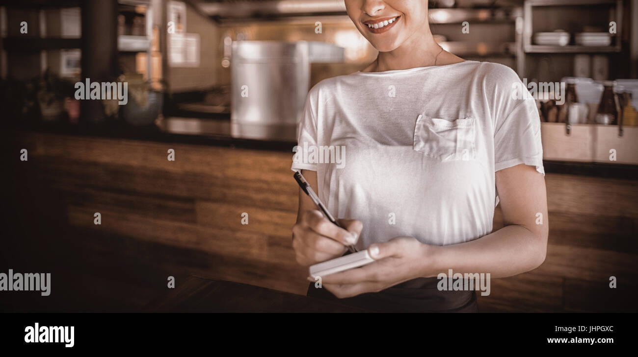 Portrait of smiling waitress standing in restaurant Stock Photo - Alamy