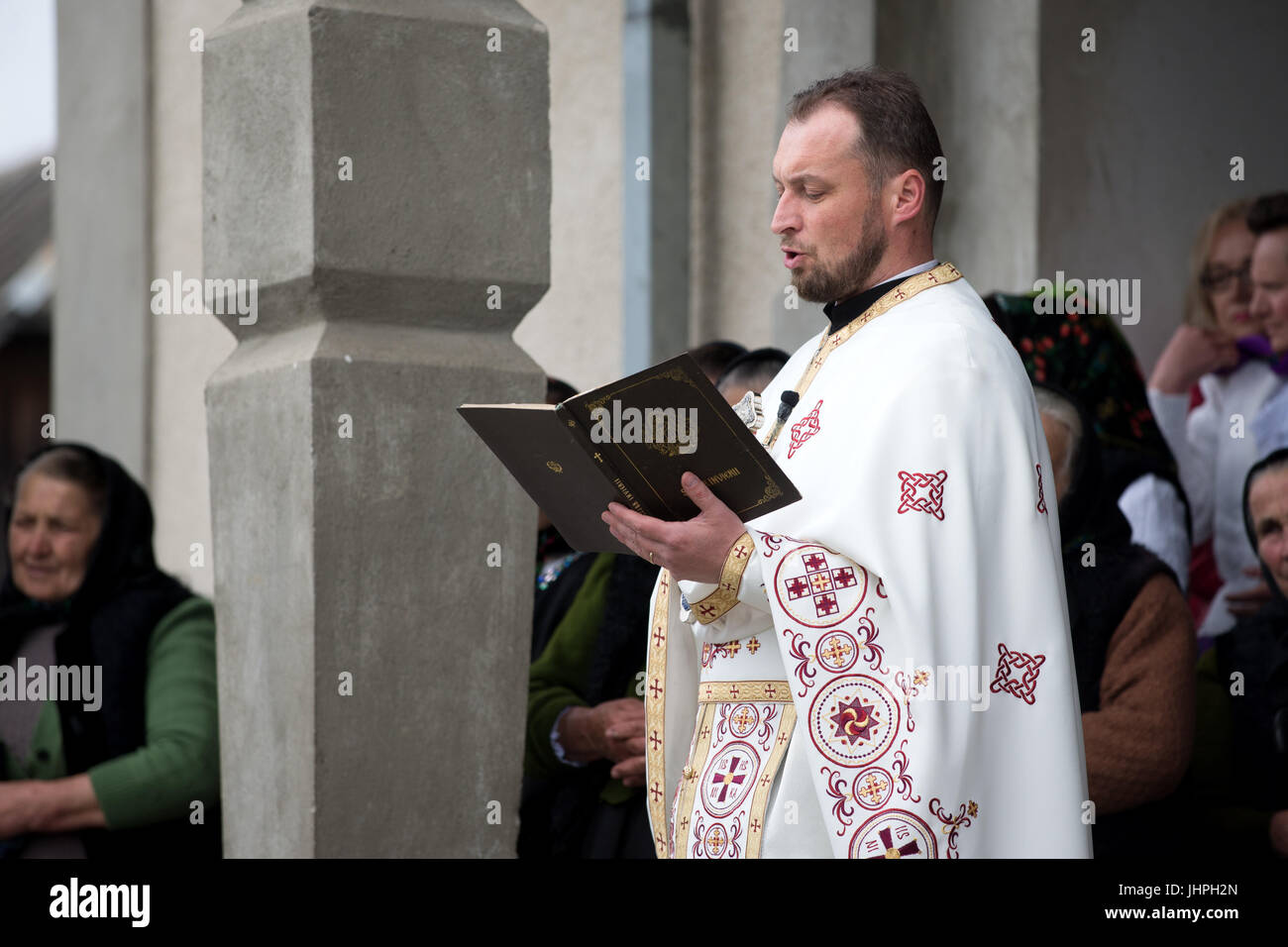 A christina orthodox priest blessing baskets of food after Eeaster mass ...