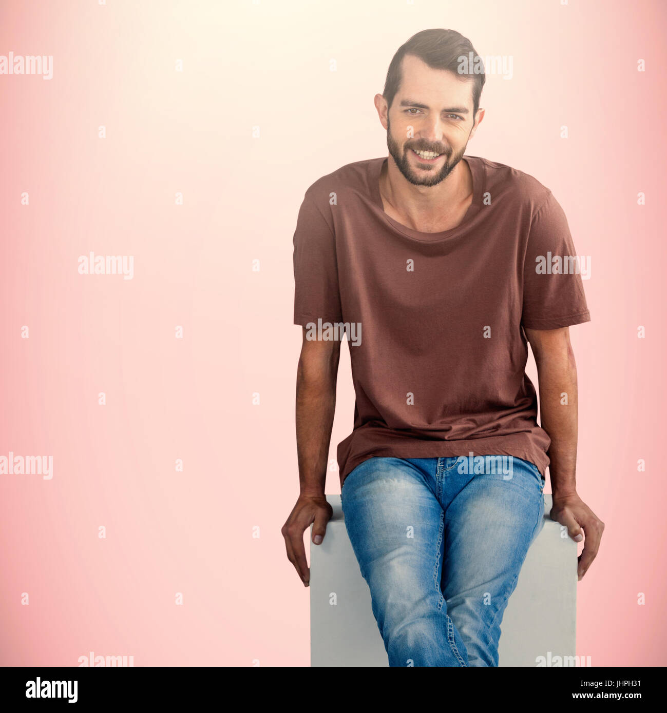 Portrait of smiling male model on seat against pink background Stock ...