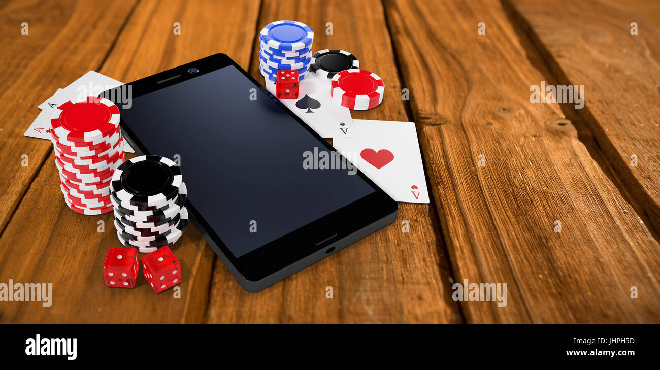 Mobile phone with playing cards and casino tokens against high angle of ...