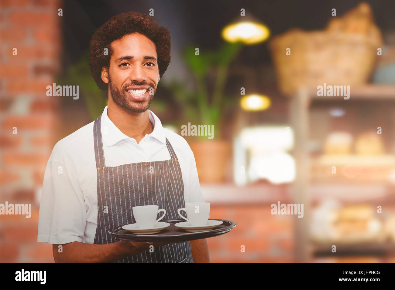 Waiter holding cup of coffee on a tray against empty counter at coffee ...