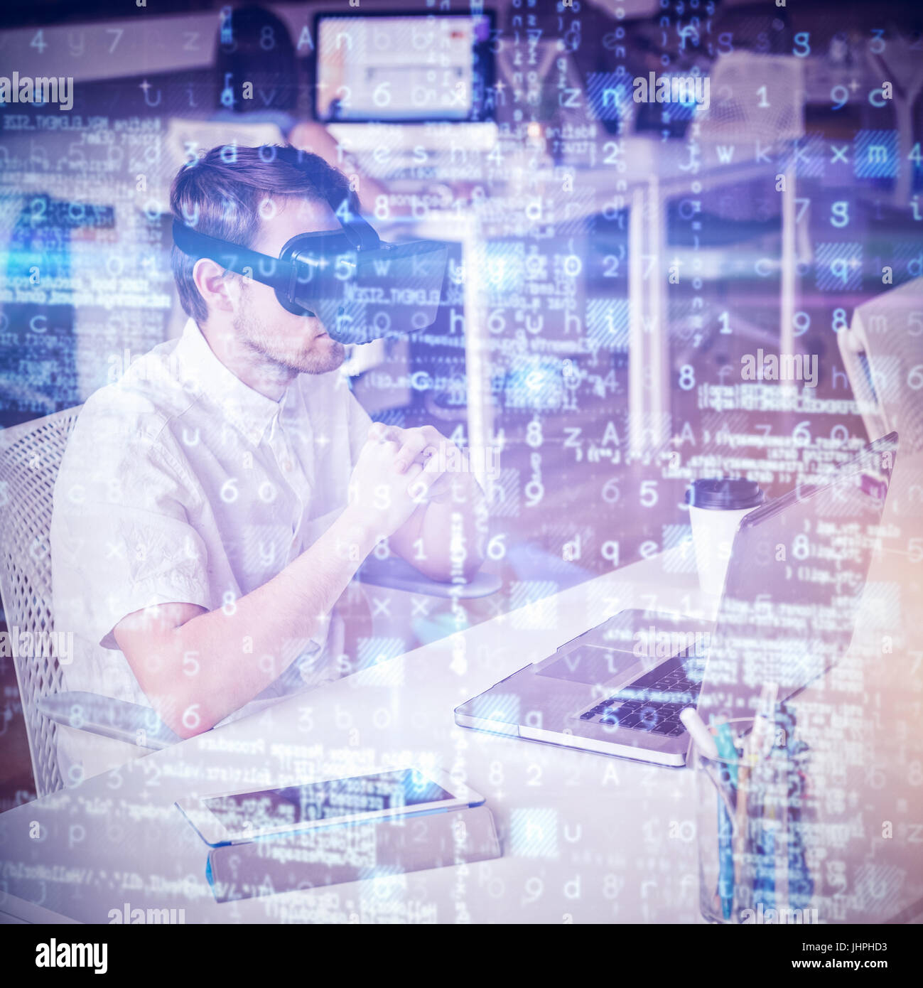 Male executive wearing virtual reality headset at table in office Stock ...