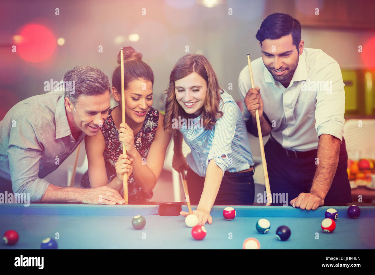 Cheerful young colleagues playing table hi-res stock photography and ...