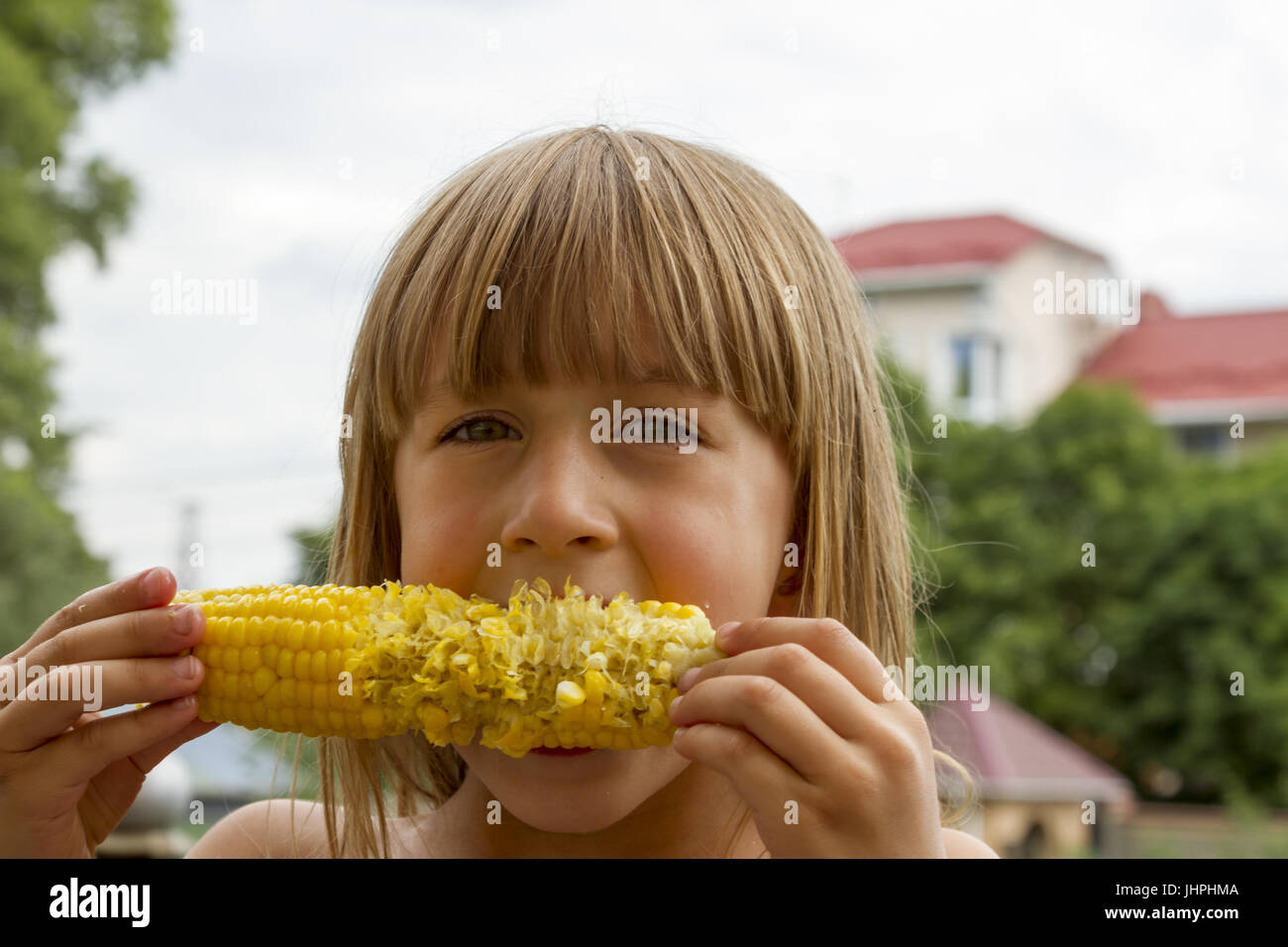 little girl eats corn Stock Photo - Alamy