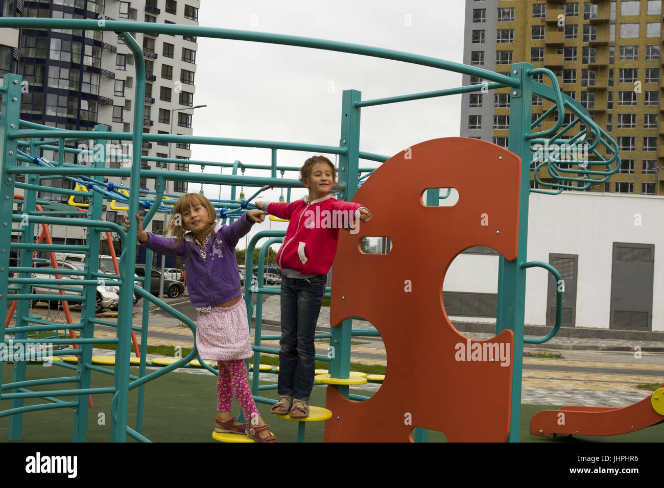 Three little children climbing ladder and looking at camera Stock Photo ...
