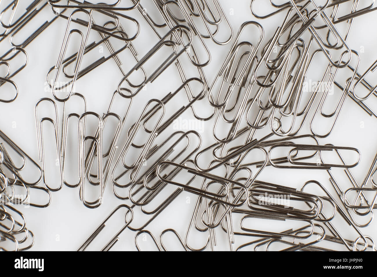 many paper clips on white background Stock Photo - Alamy