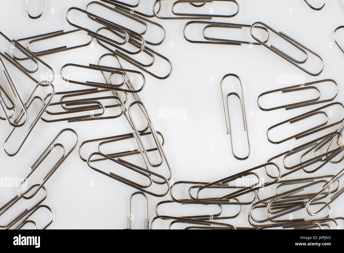 many paper clips on white background Stock Photo - Alamy