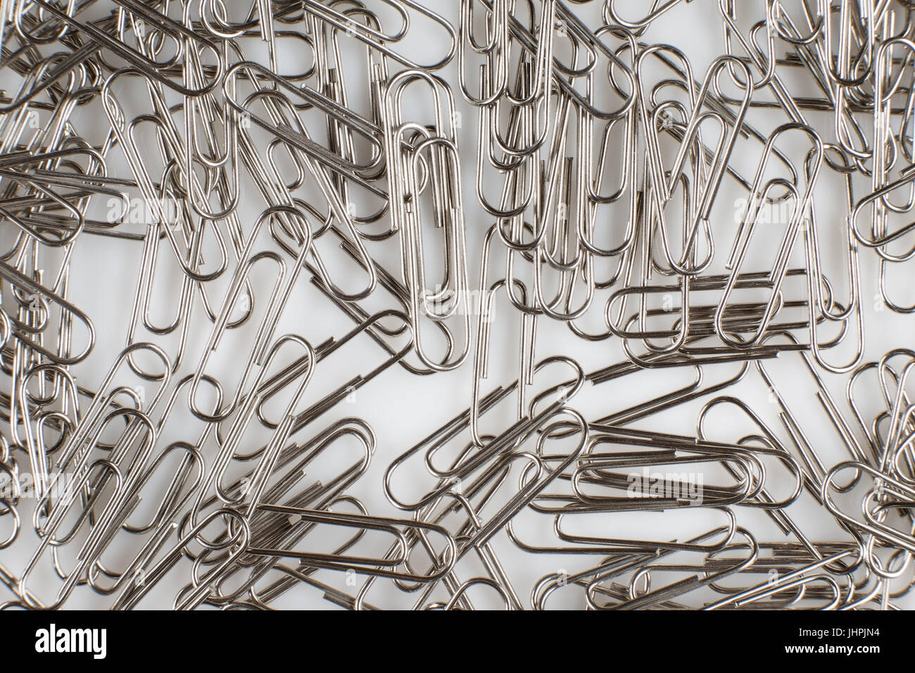 many paper clips on white background Stock Photo - Alamy