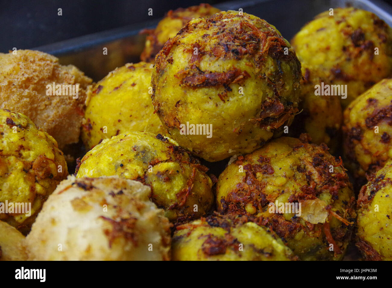 Close up of bolon of plantain mixed with hornado roasted pork ...