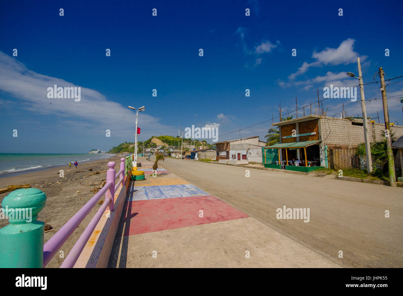 Rocky pavement road in the coast, surrounded with abundat vegetation in ...