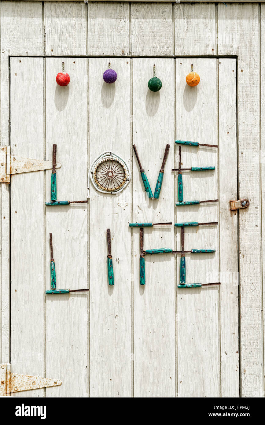 Sign in attached wooden letters on the door of a beach shed Stock Photo ...