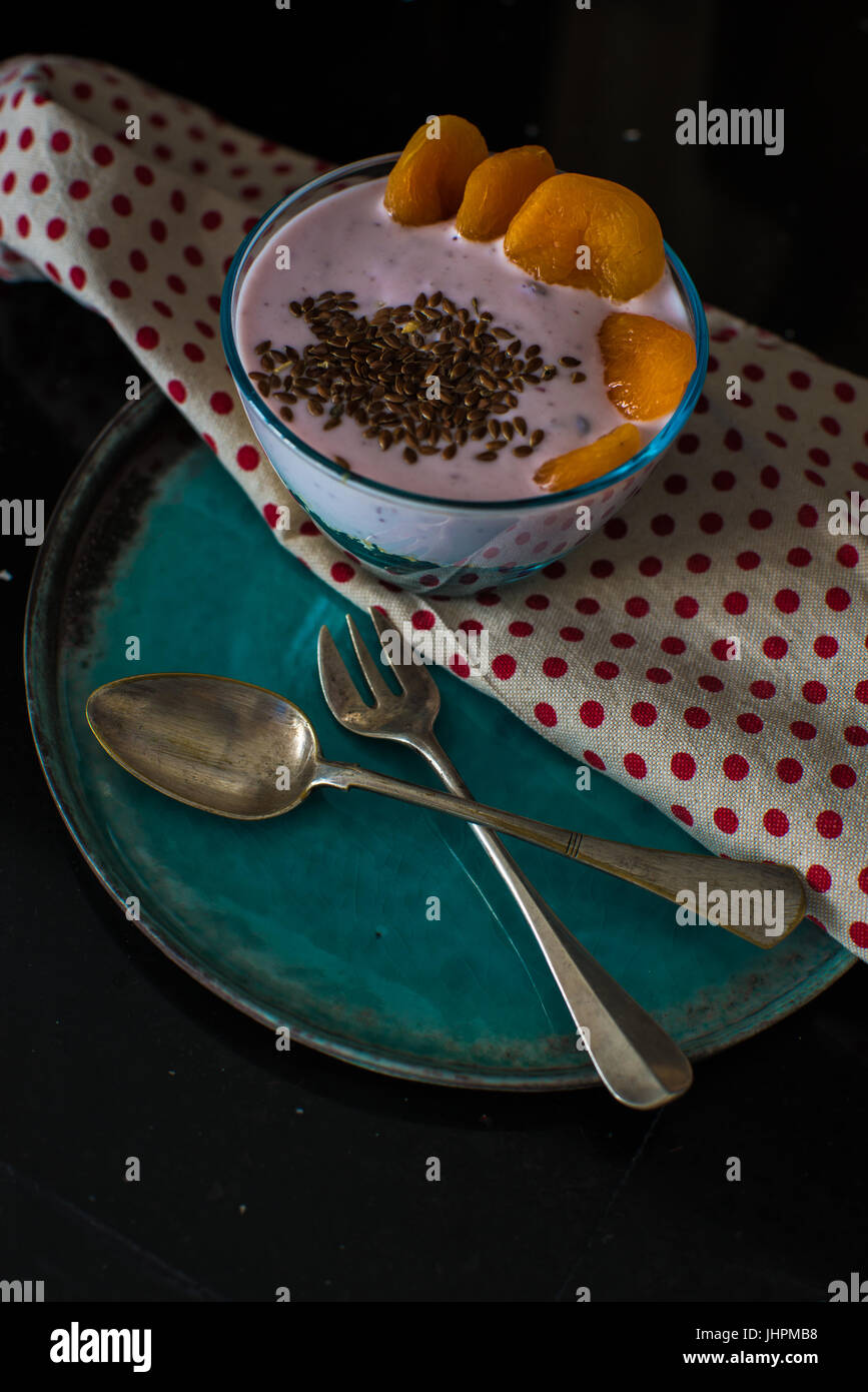 Healthy breakast corn flakes in a bowl and glass of milk on rustic ...