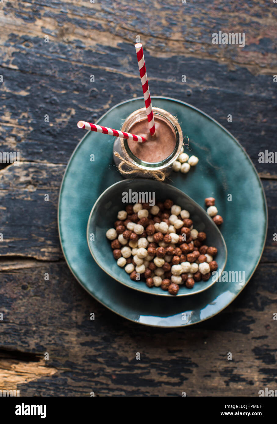 Healthy breakast corn flakes in a bowl and glass of milk on rustic ...