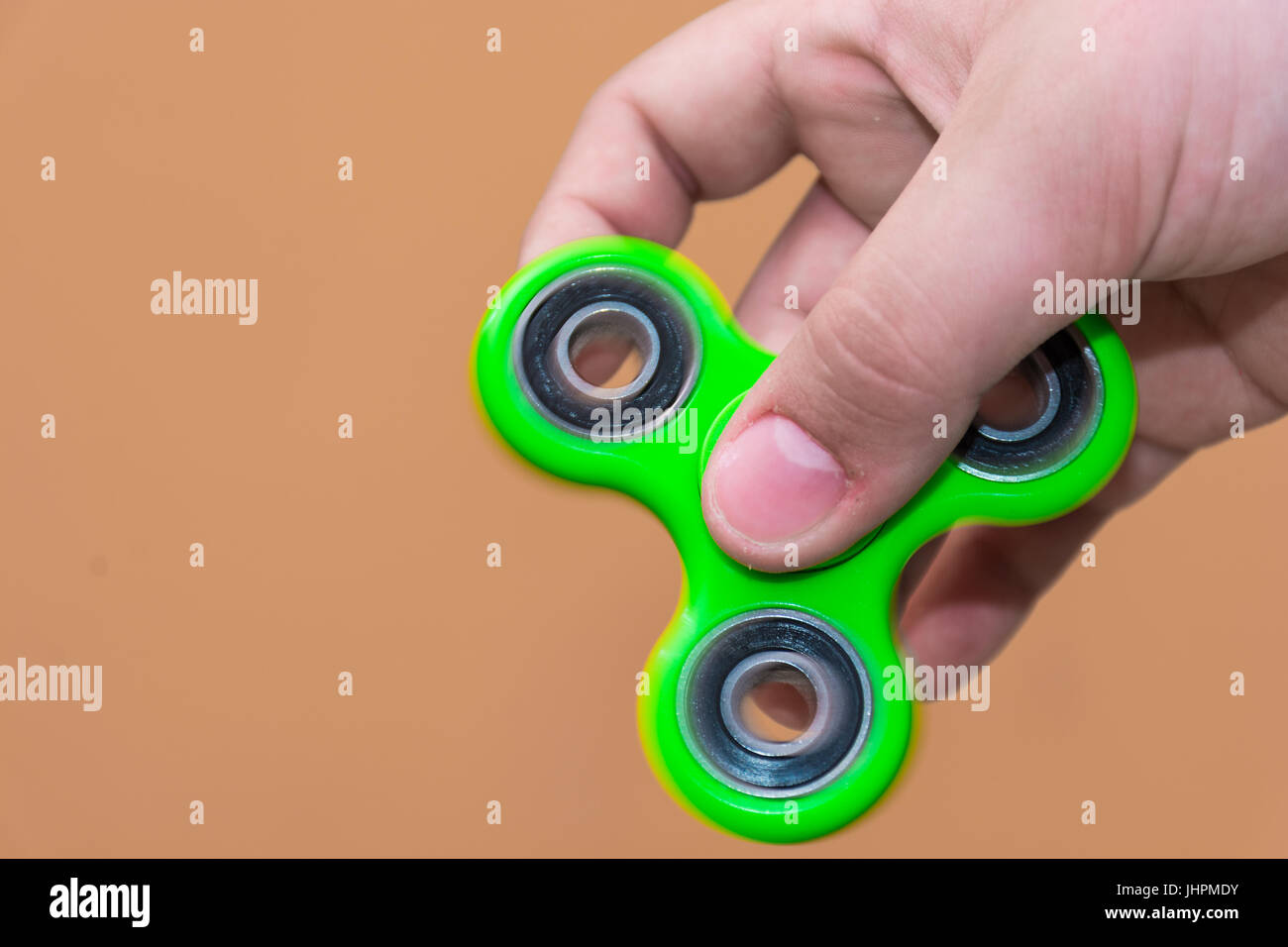 Boy playing with fidget spinner gadget. The fidget spinner is a toy, a ...