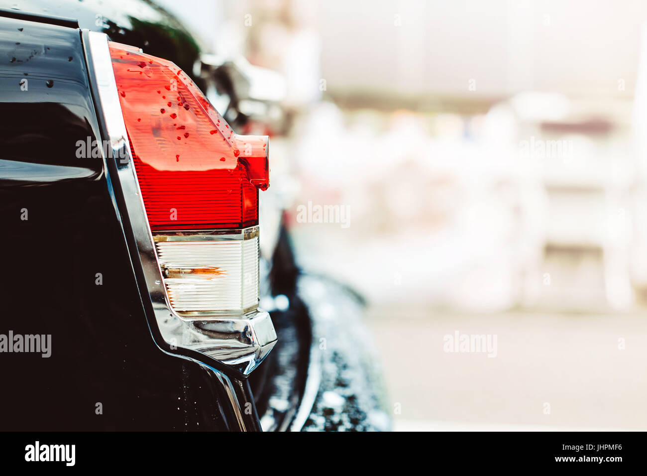 Retro car rear lantern on city street Stock Photo - Alamy