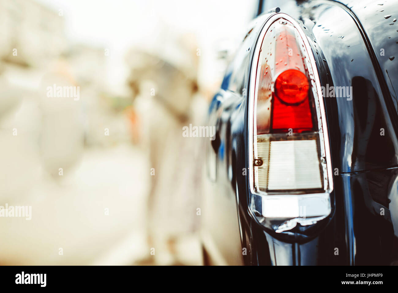 Retro car rear lantern on city street Stock Photo - Alamy
