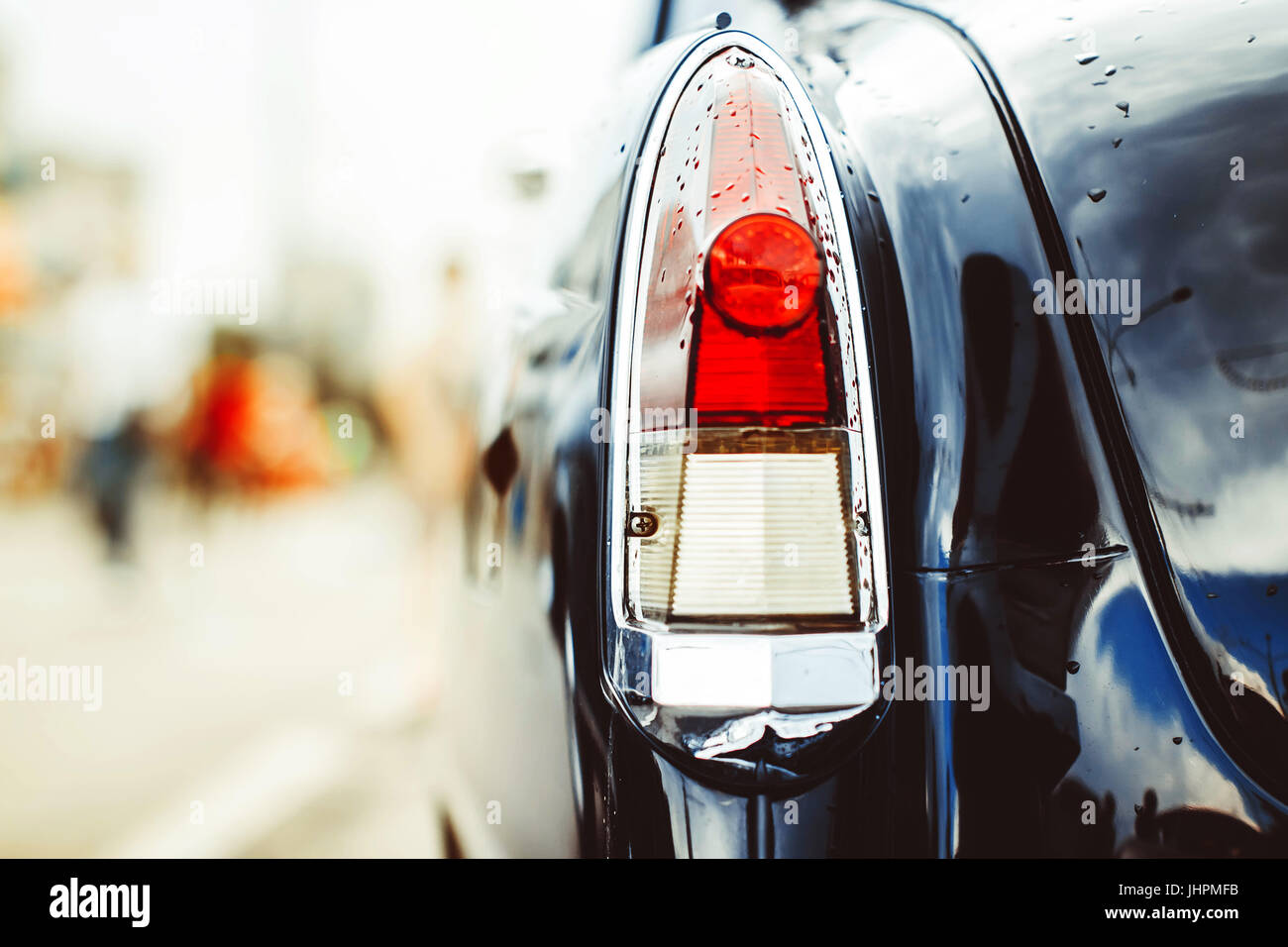 Retro car rear lantern on city street Stock Photo - Alamy