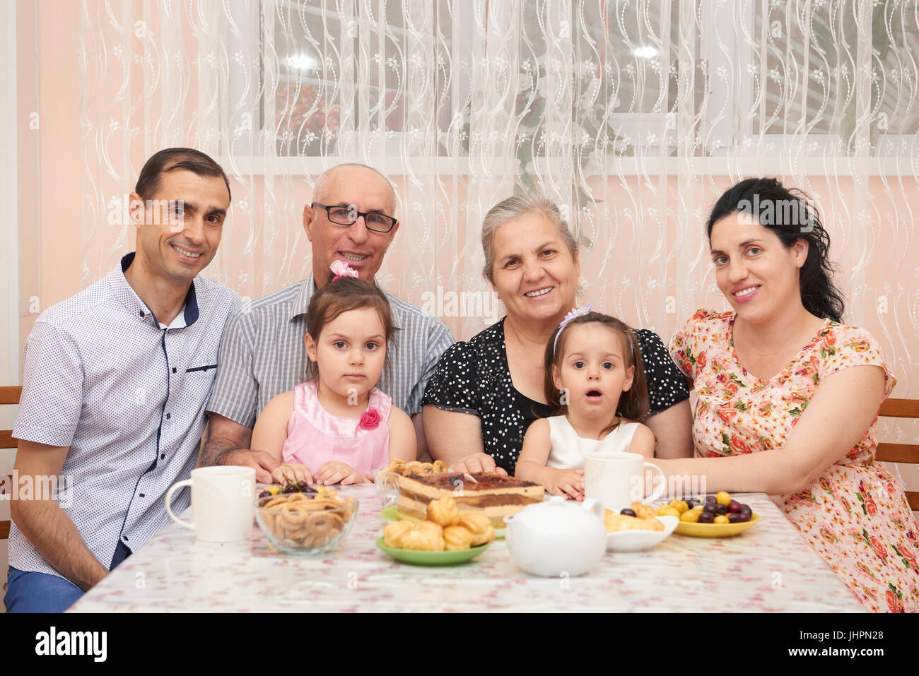 big family drinking tea in dining room Stock Photo - Alamy
