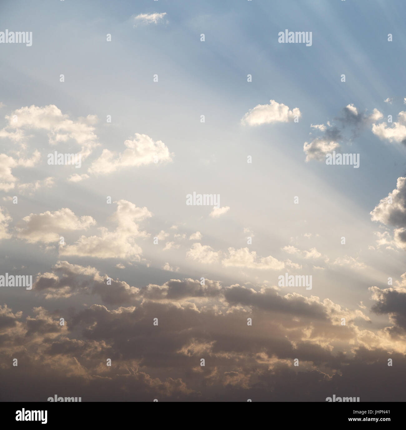 in the empty sky lots of clouds and sunny ray of light Stock Photo - Alamy