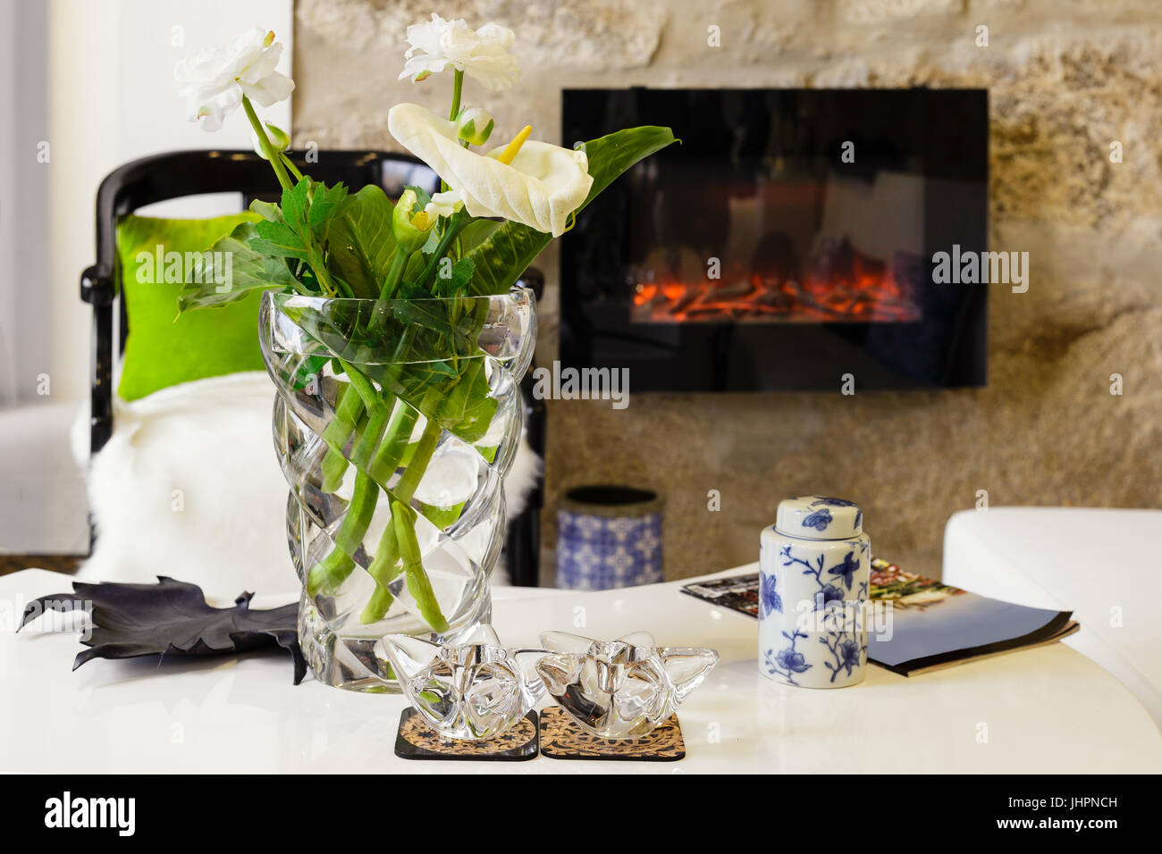 Flower Vase on Table in a room with a fireplace Stock Photo - Alamy