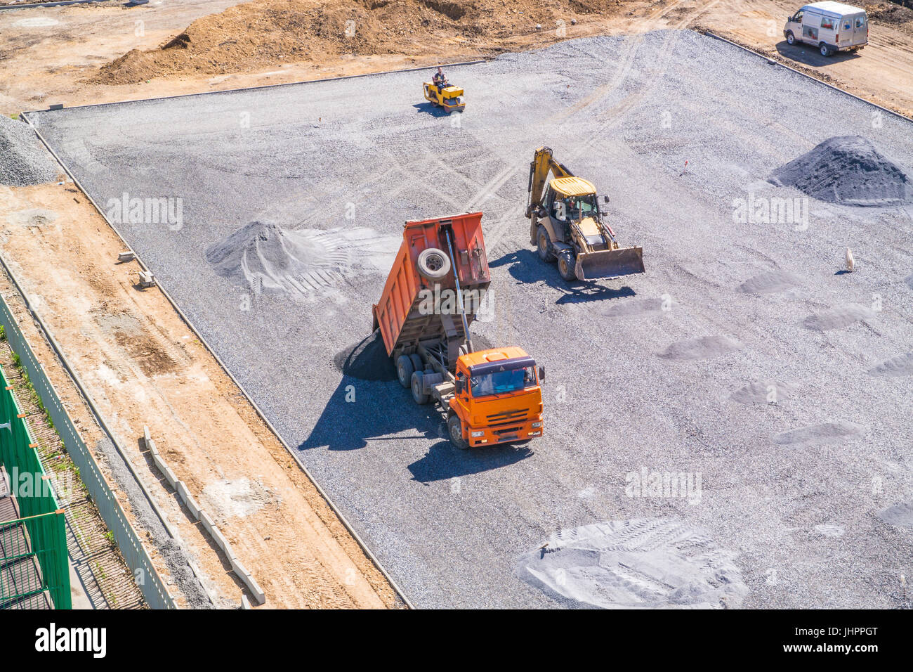 Dump truck unloads asphalt at the construction site of the school ...