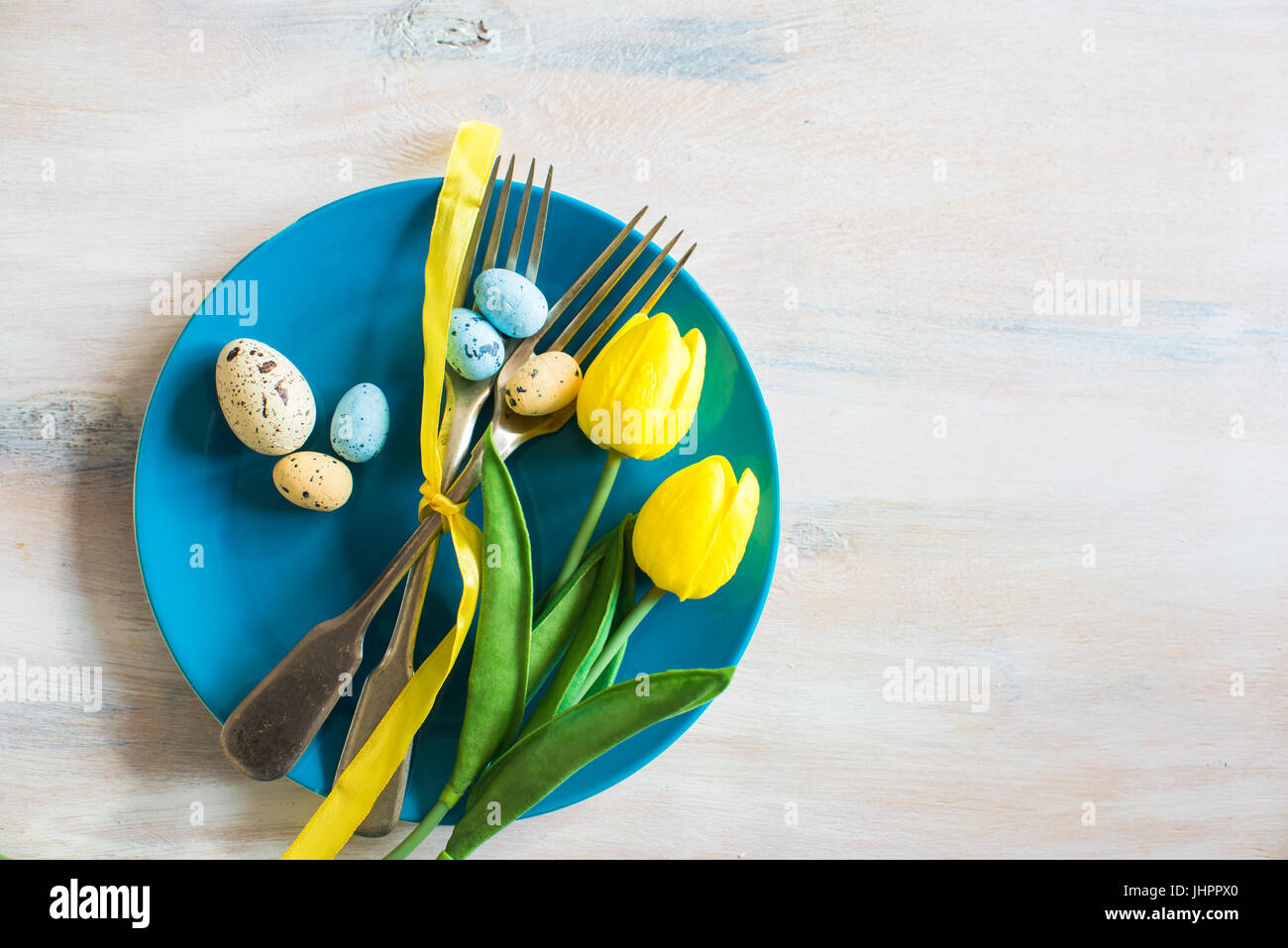 Festive table setting for Easter dinner on wooden rustic table Stock ...