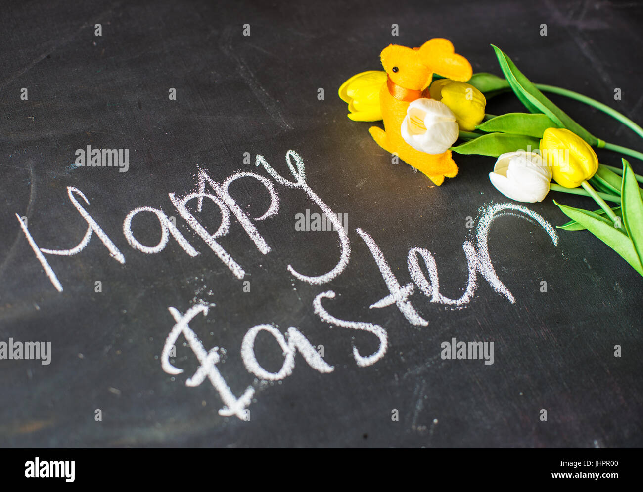 Easter festive frame with eggs, tulips and easter bunny on white rustic ...