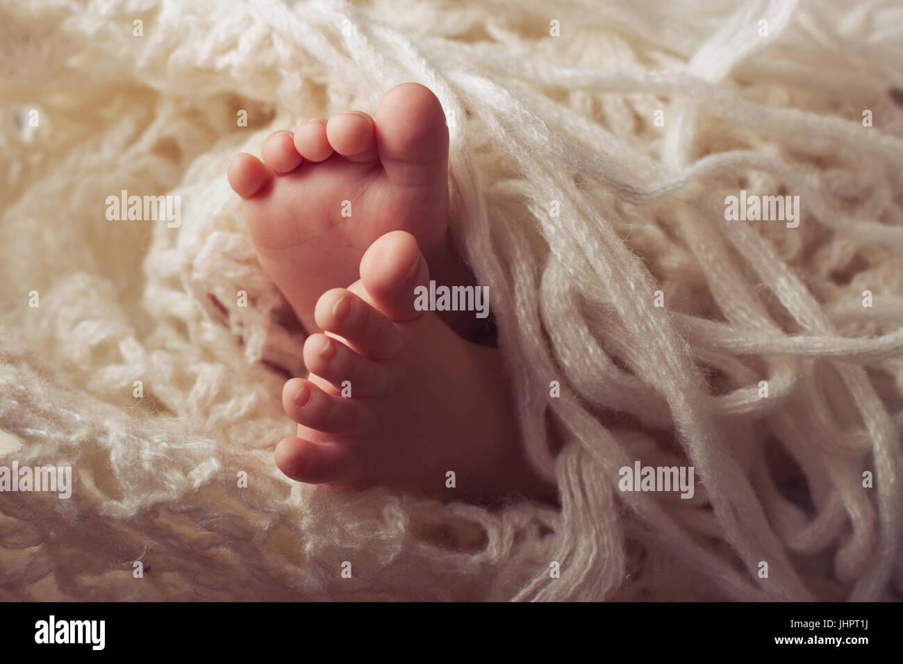 Legs of a young child wrapped in a blanket Stock Photo - Alamy
