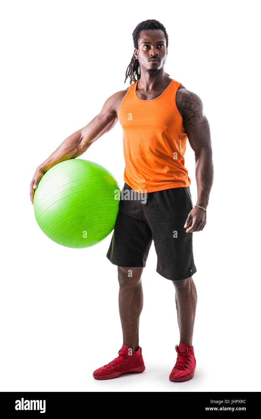 Muscular black man holding inflatable fitness ball, looking at camera ...