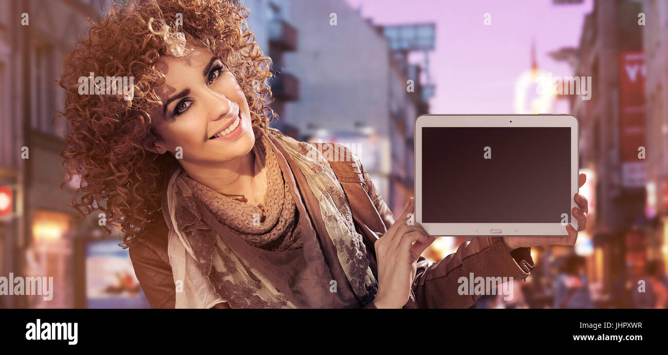 Closeup portrait of a young pretty woman with an electronic device ...