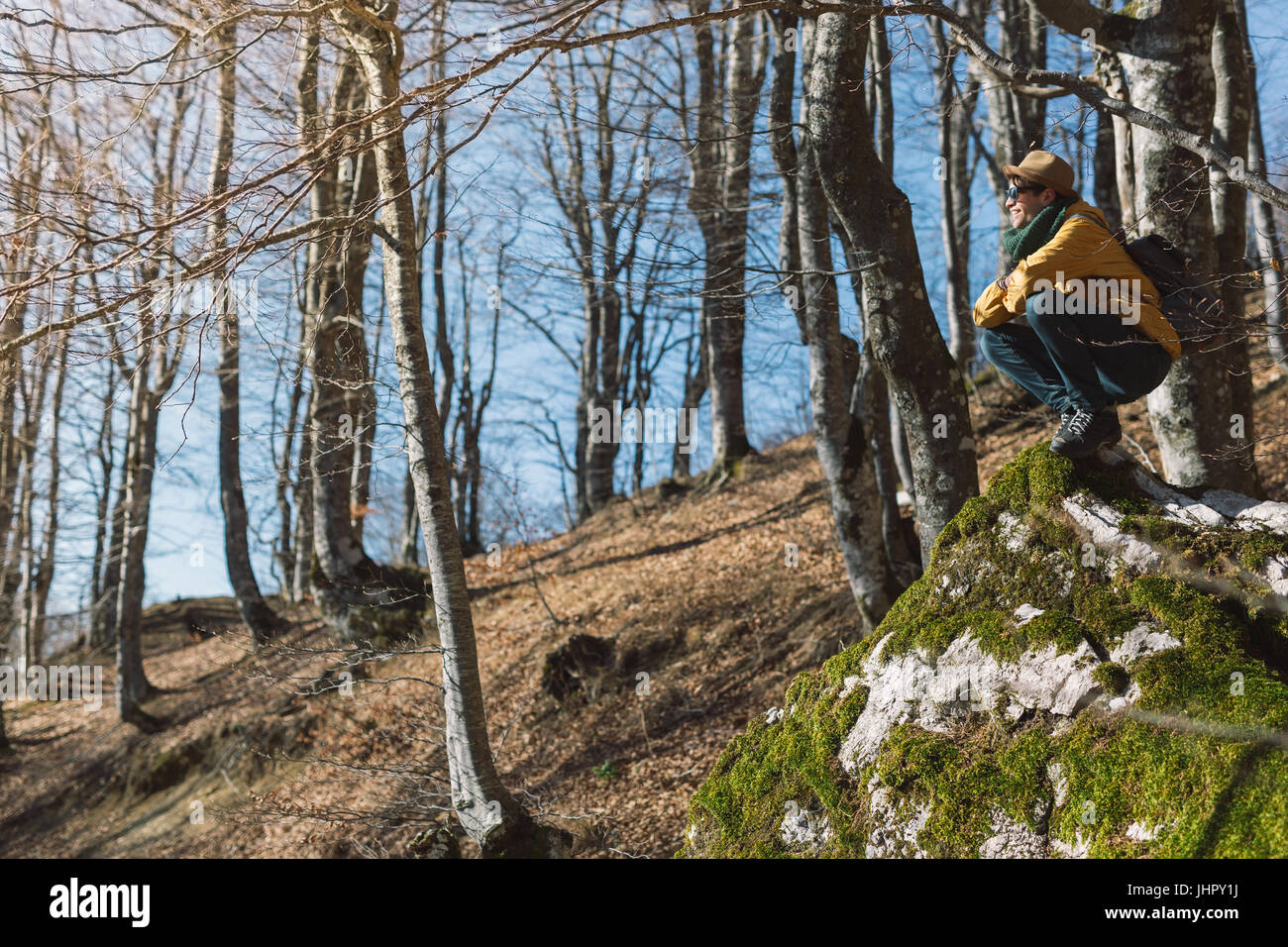 Young man standing in the forest and exploring, freedom and nature ...