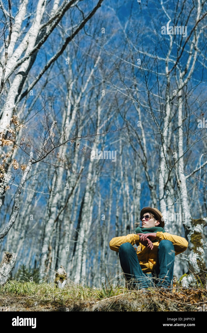 Young man standing in the forest and exploring, freedom and nature ...
