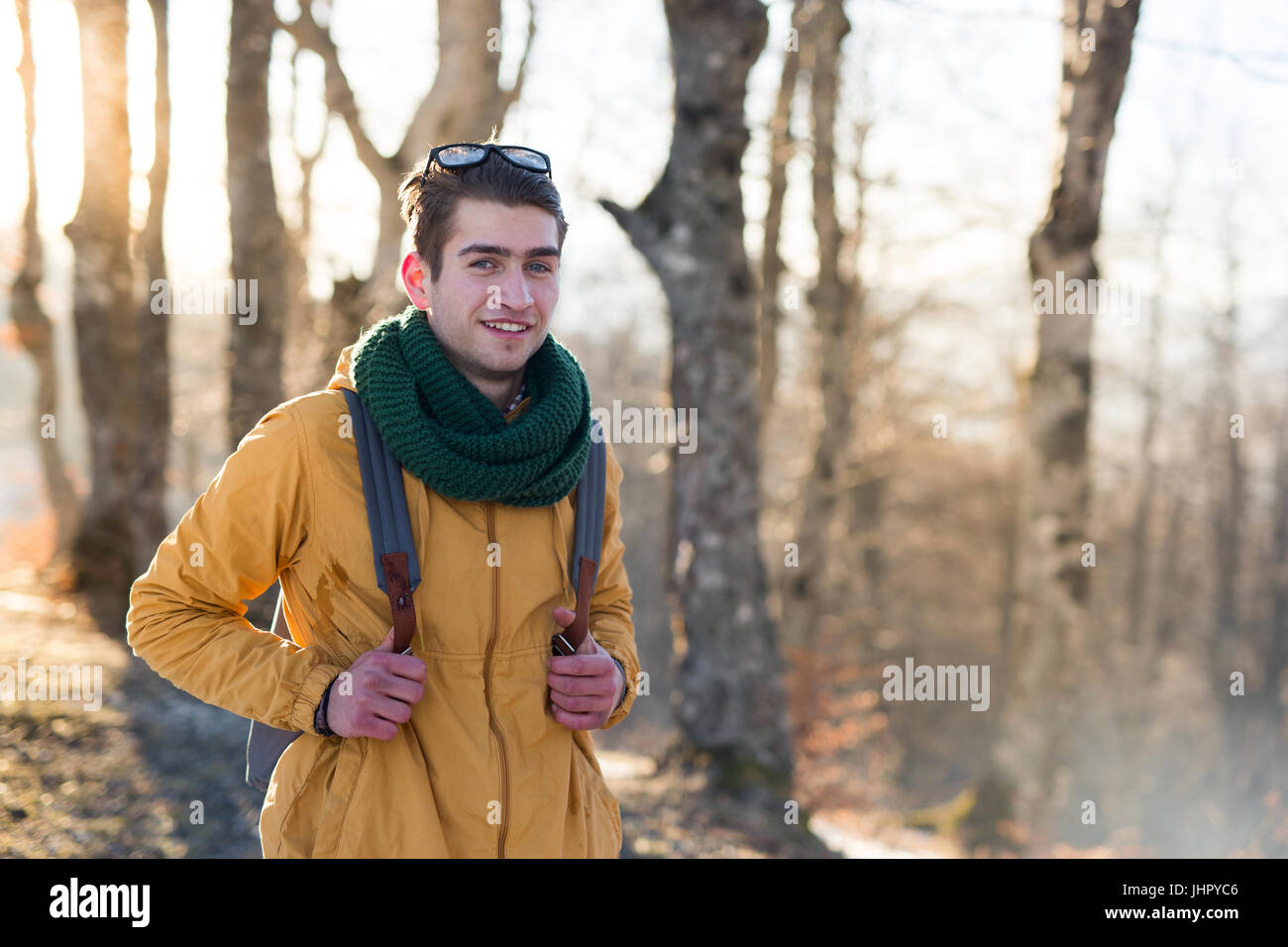 Young man standing in the forest and exploring, freedom and nature ...