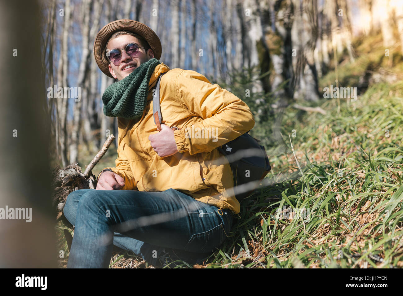 Young man standing in the forest and exploring, freedom and nature ...