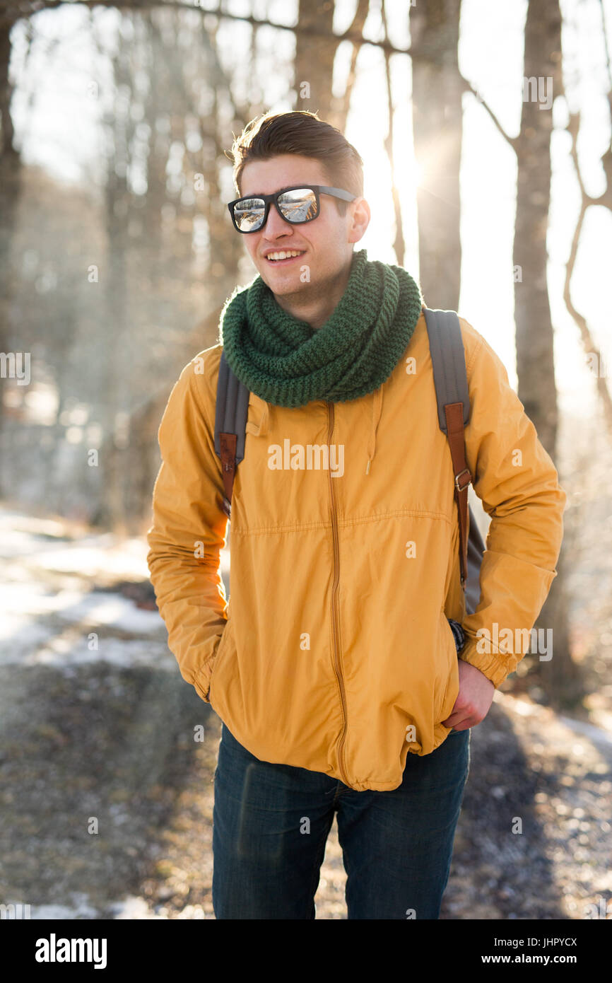 Young man standing in the forest and exploring, freedom and nature ...