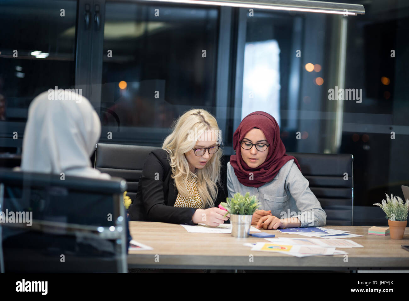 Colleagues working overtime in their office. Working a night shift in ...