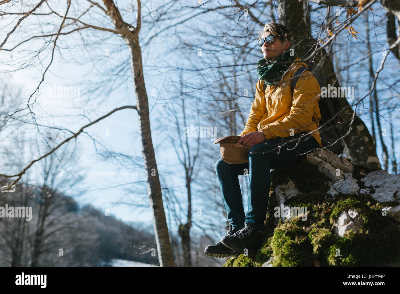 Young man standing in the forest and exploring, freedom and nature ...