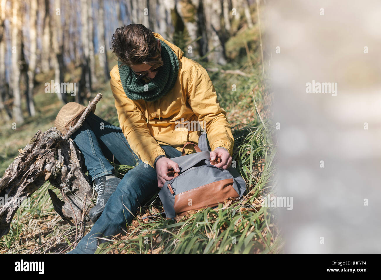 Young man standing in the forest and exploring, freedom and nature ...