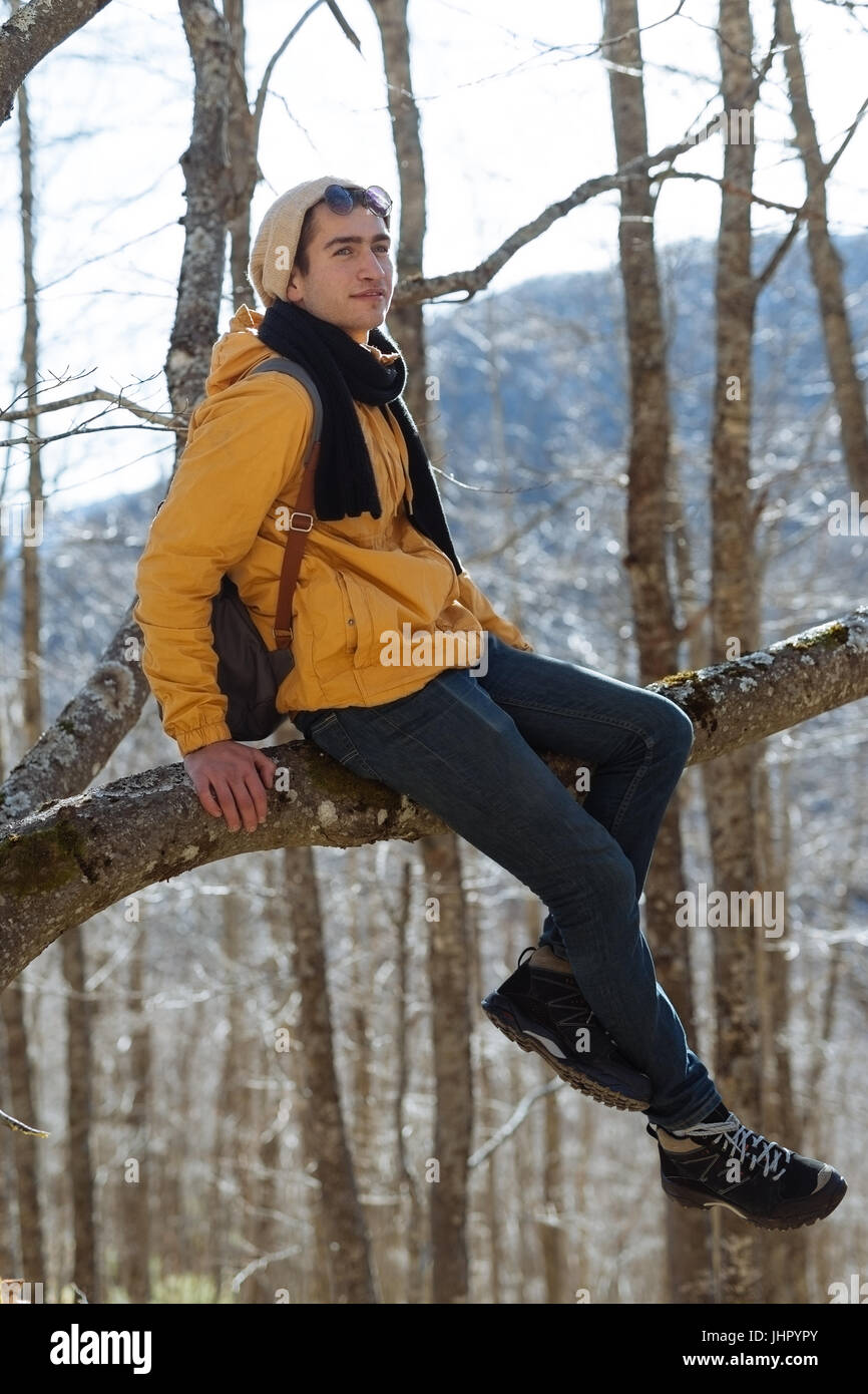 Young man standing in the forest and exploring, freedom and nature ...