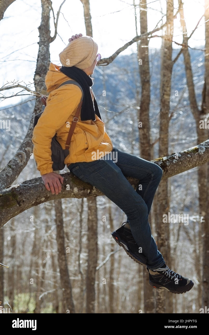 Young man standing in the forest and exploring, freedom and nature ...